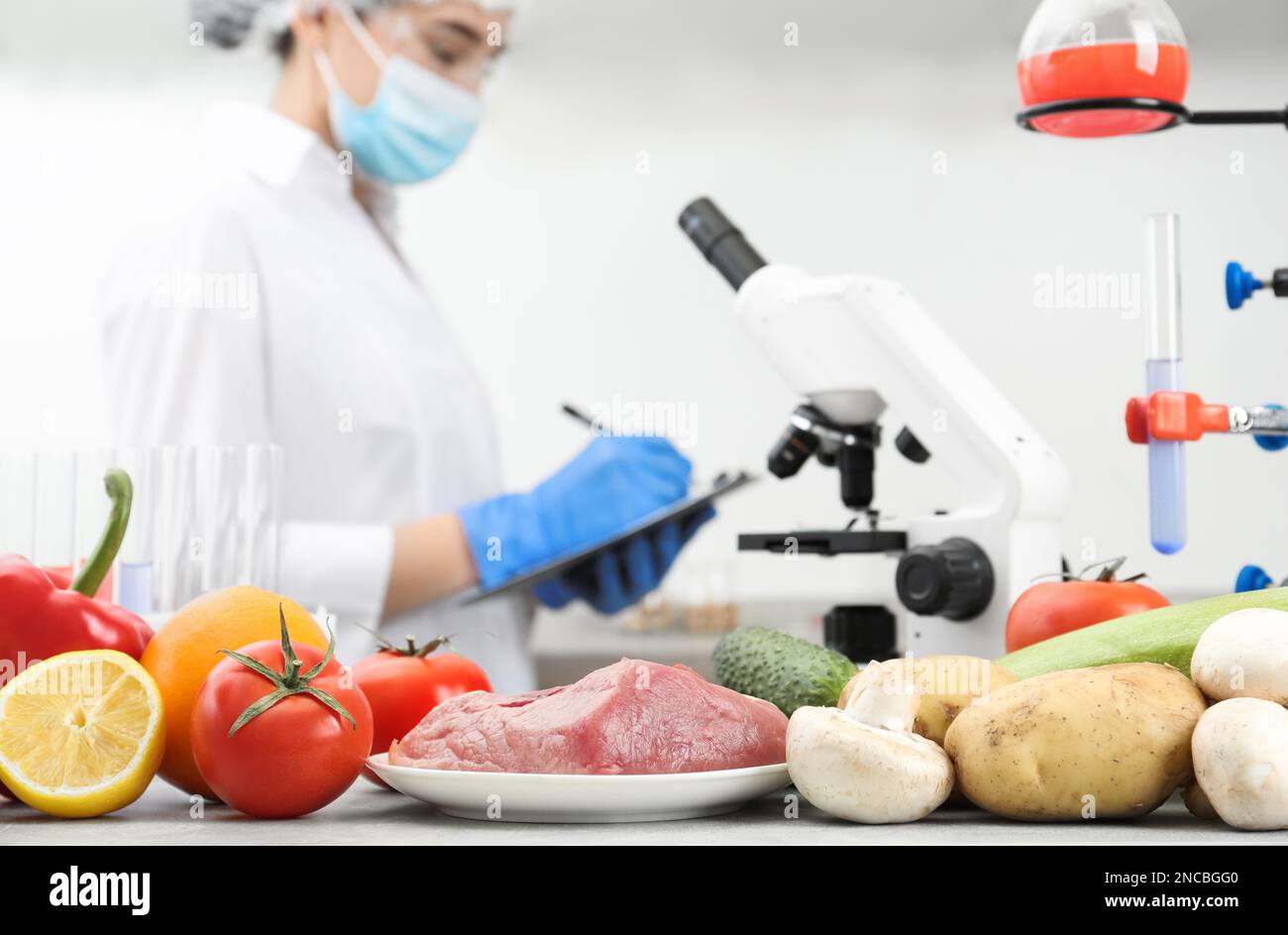 Different products on table and scientist in laboratory. Quality ...