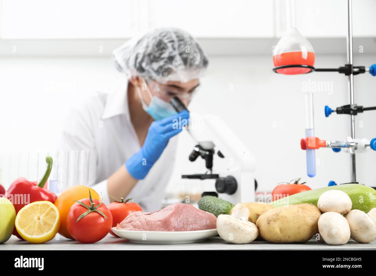 Scientist checking products at table in laboratory. Quality control ...
