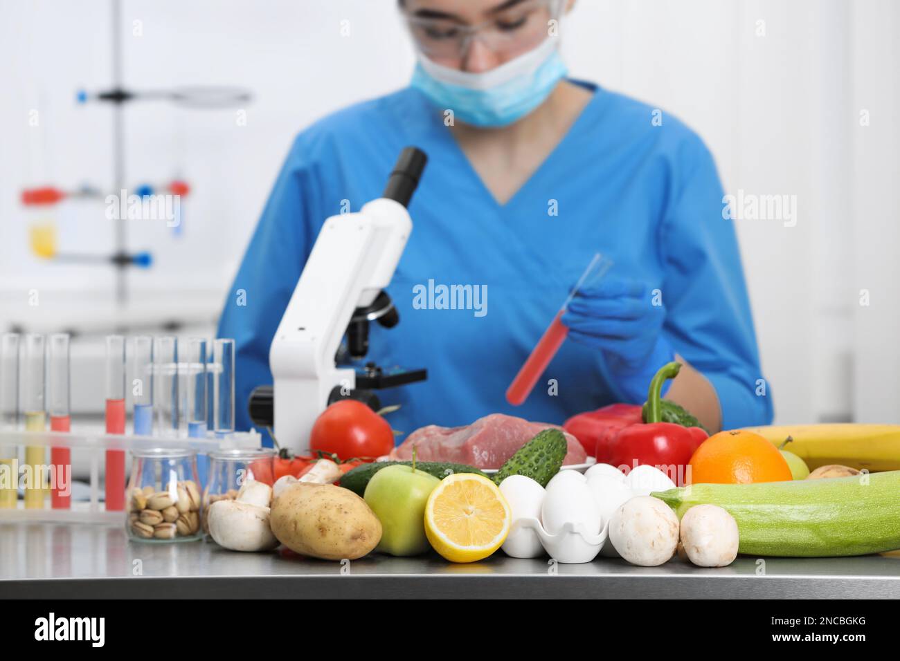 Scientist checking products at table in laboratory. Quality control ...