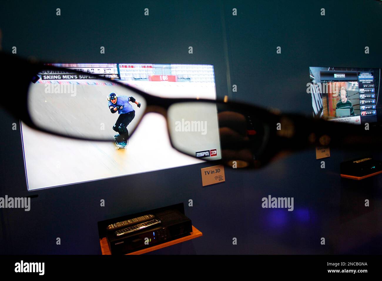 Consumers wear 3D glasses to watch Time Warner Cable's 3D television at ...