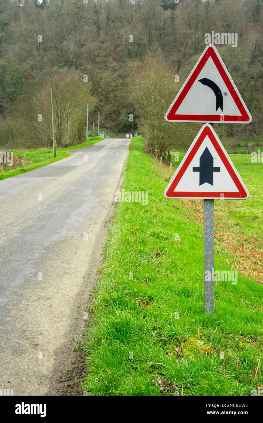 Road and road sign warning about a turn in the road. Road safety ...