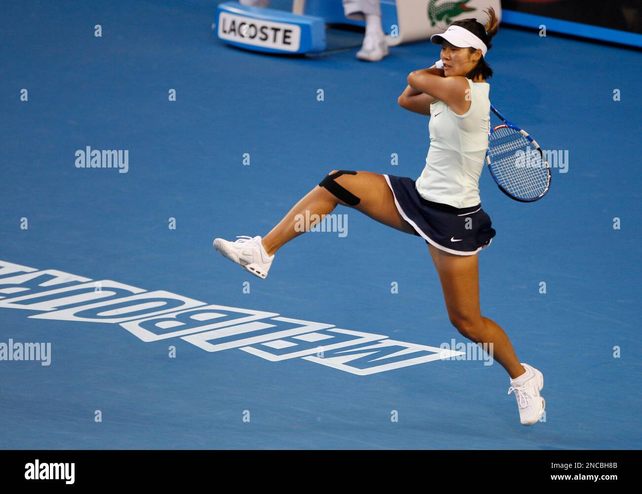 China's Li Na hits a backhand return to Belgium's Kim Clijsters during ...