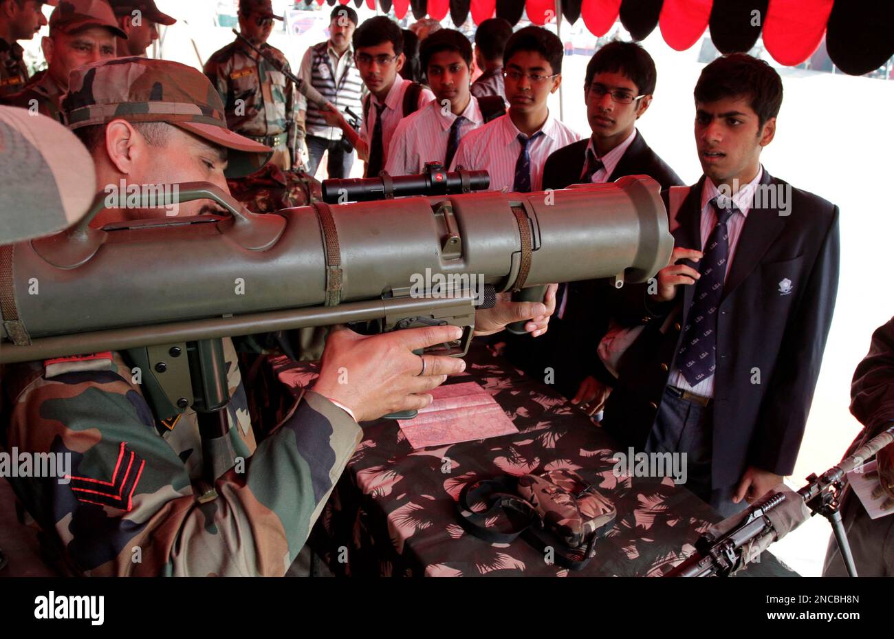 An Indian army soldier demonstrates the functions of a self-propelled ...