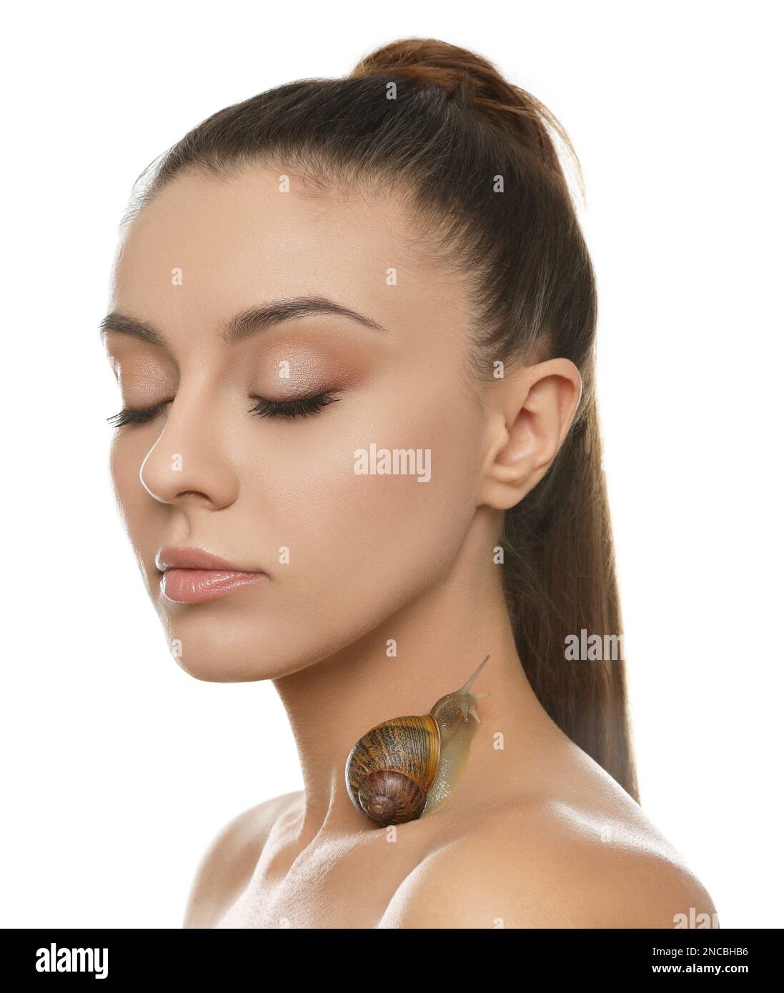 Beautiful young woman with snail on her neck against white background ...