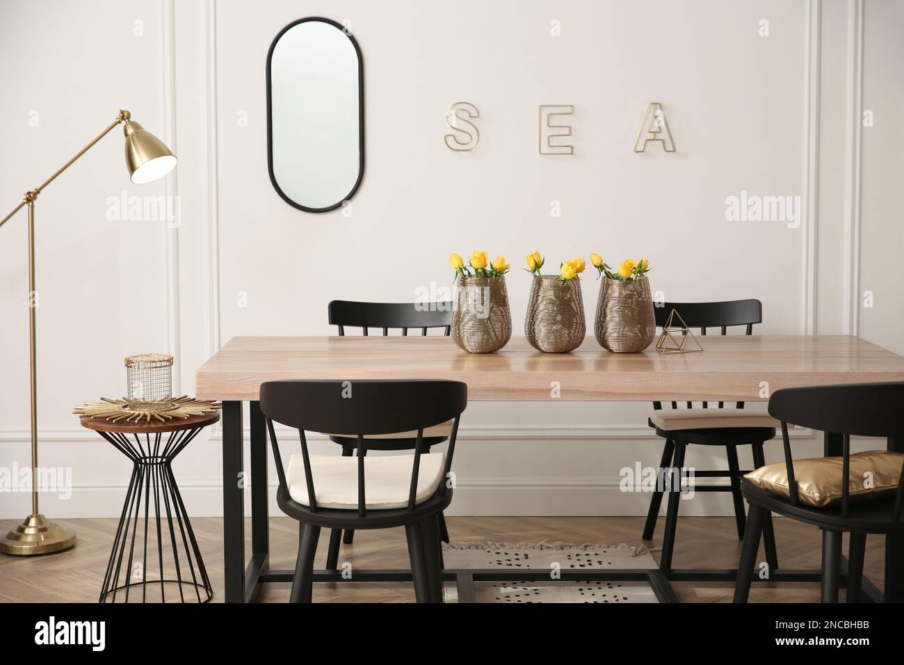 Stylish wooden dining table and chairs in room. Interior design Stock ...