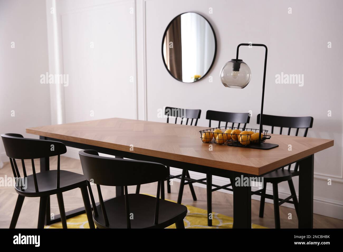 Stylish wooden dining table and chairs in room. Interior design Stock ...