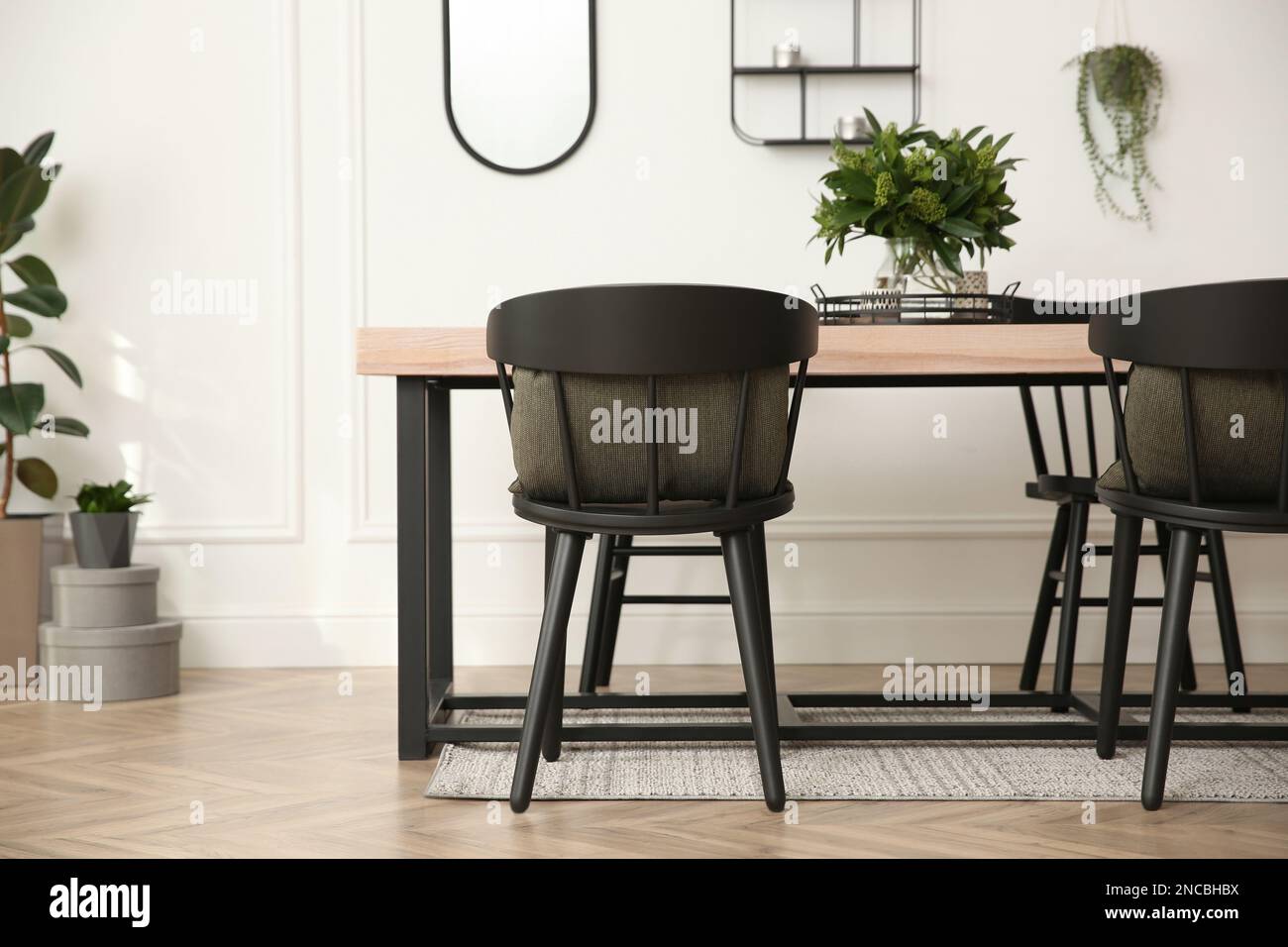 Stylish wooden dining table and chairs in room. Interior design Stock ...
