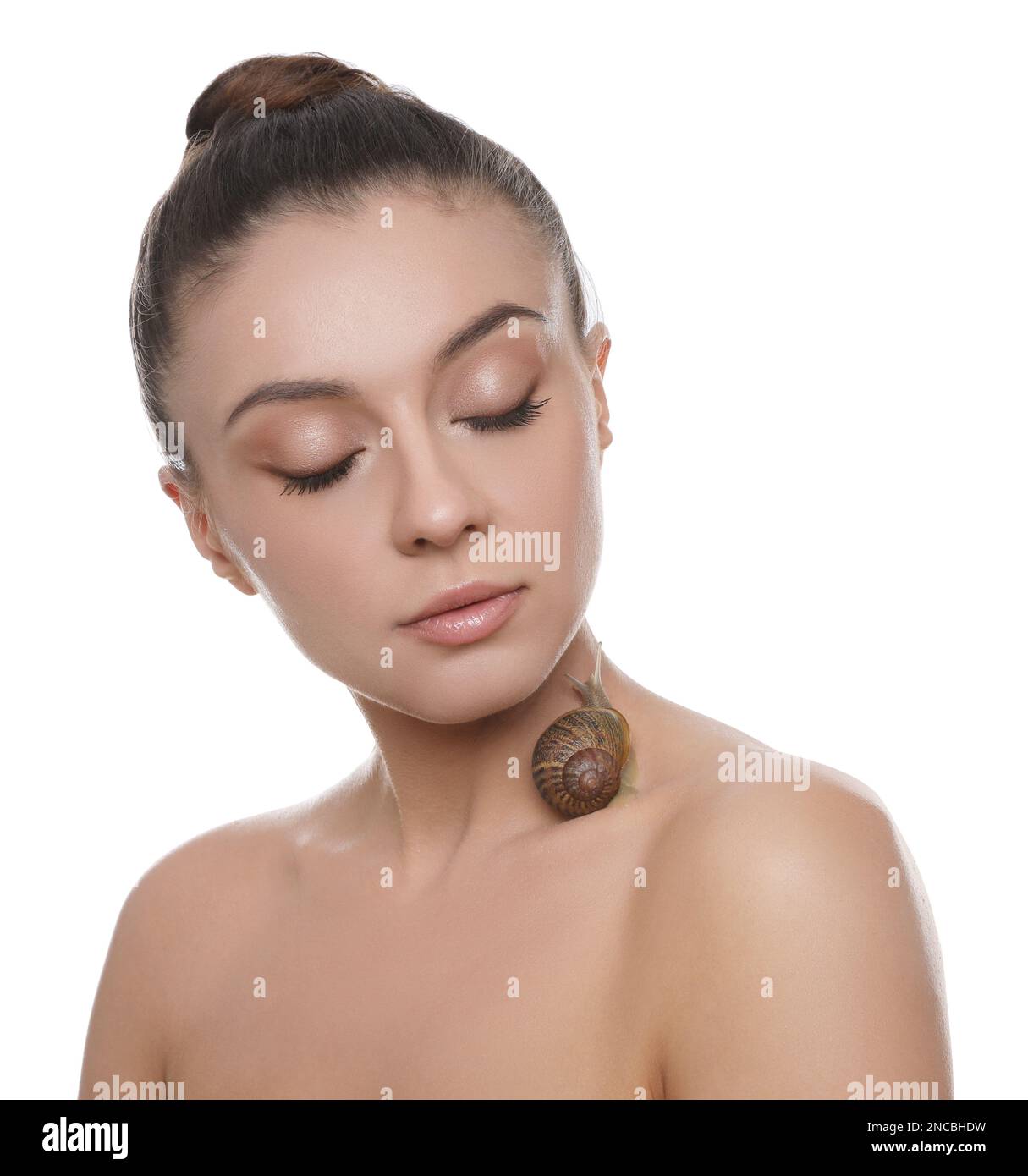 Beautiful young woman with snail on her neck against white background ...