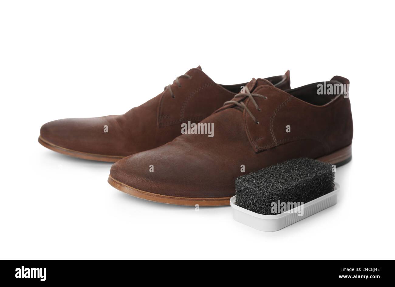 Stylish footwear and cleaning sponge on white background. Shoes care ...