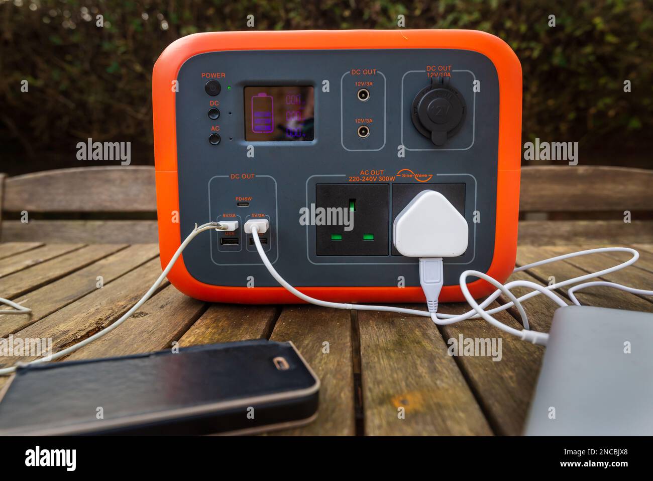 Portable power station solar electricity generator on table with mobile ...