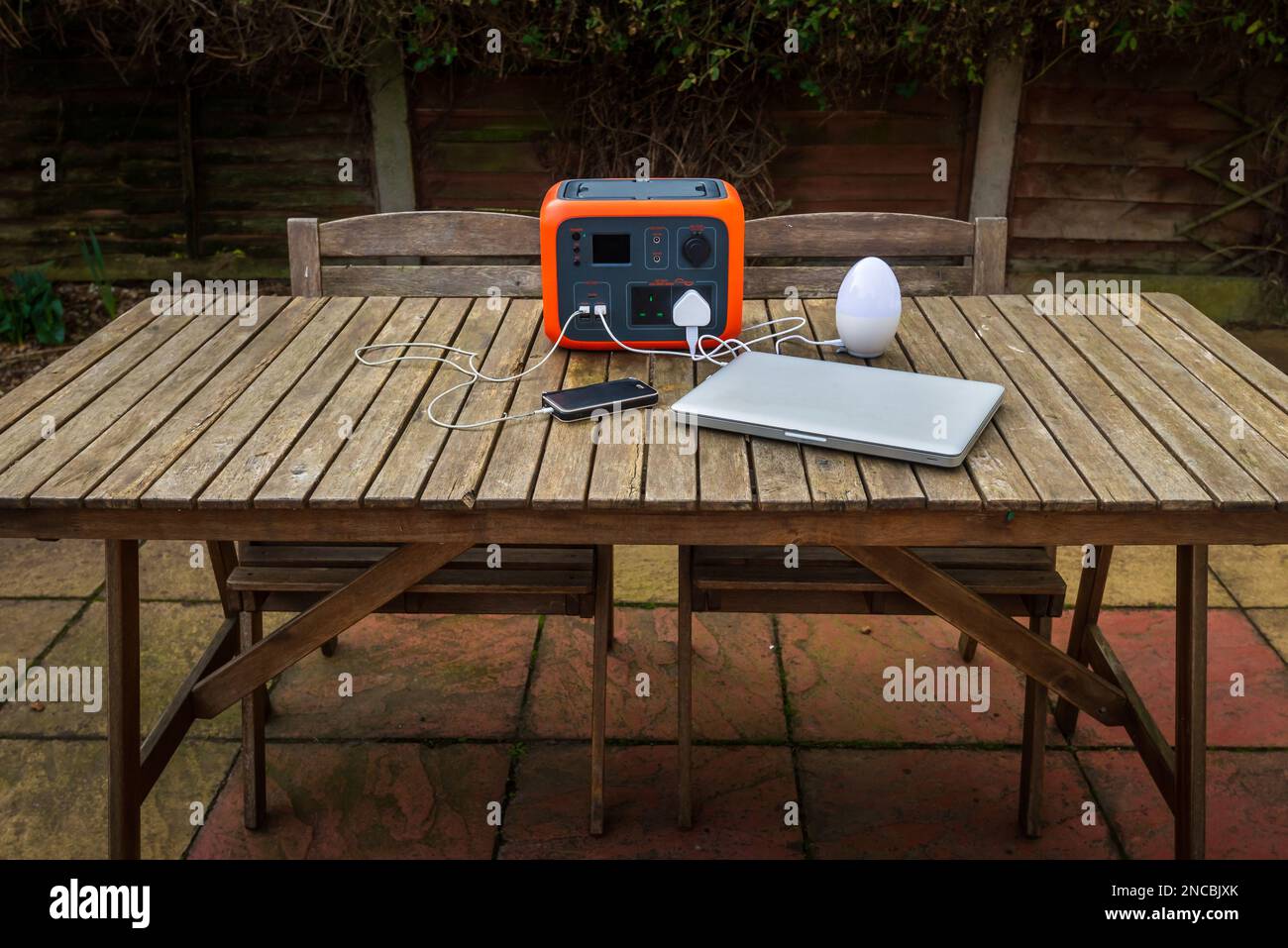 Portable power station solar electricity generator on table with laptop ...