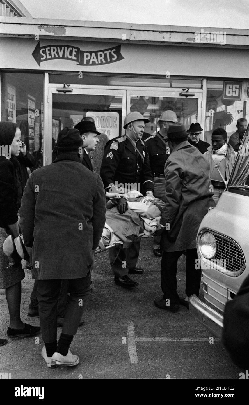 A state patrol sergeant helps load an injured demonstrator into ...
