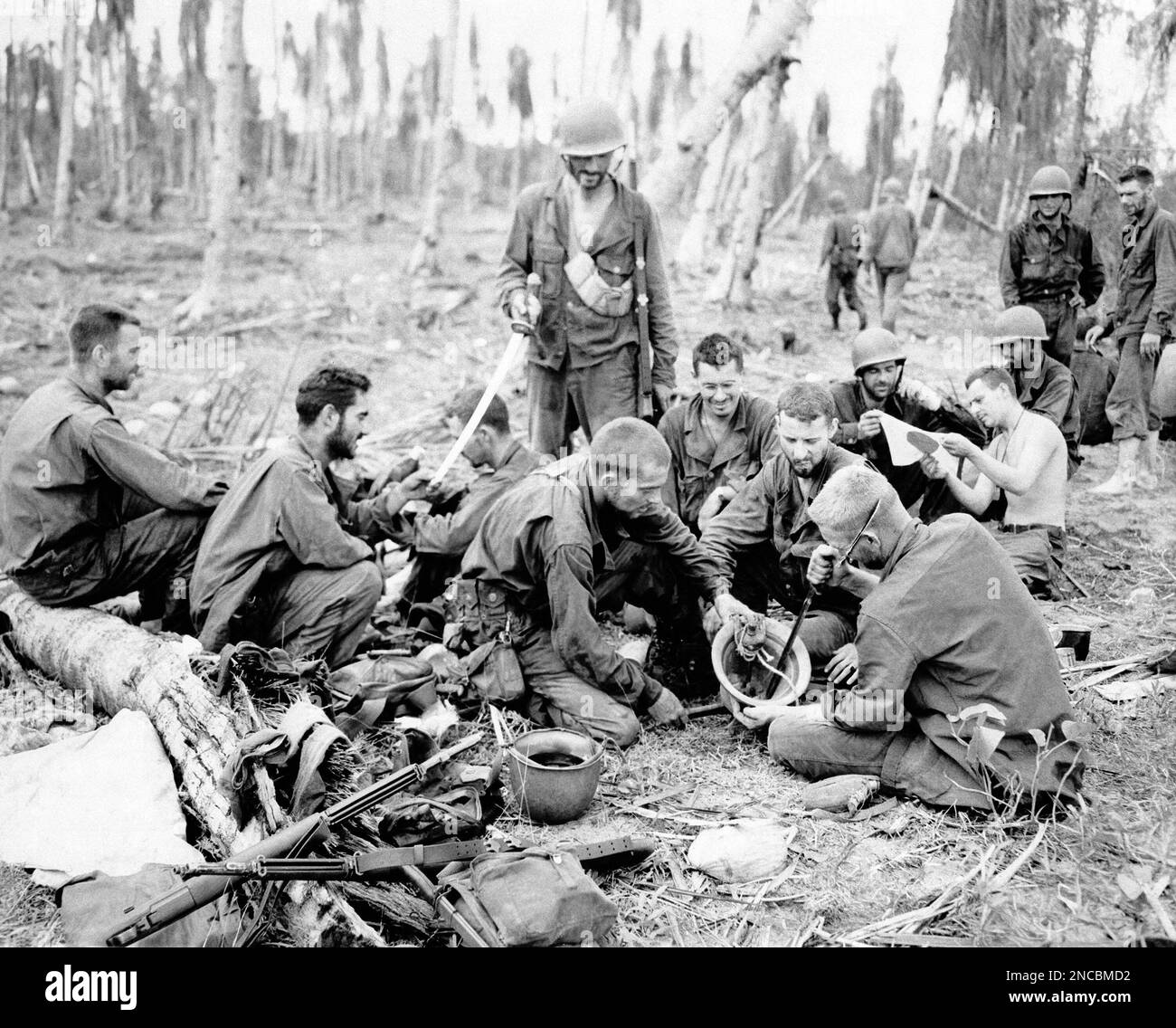 Men of the U.S. 32nd division task force examine trophies during a ...