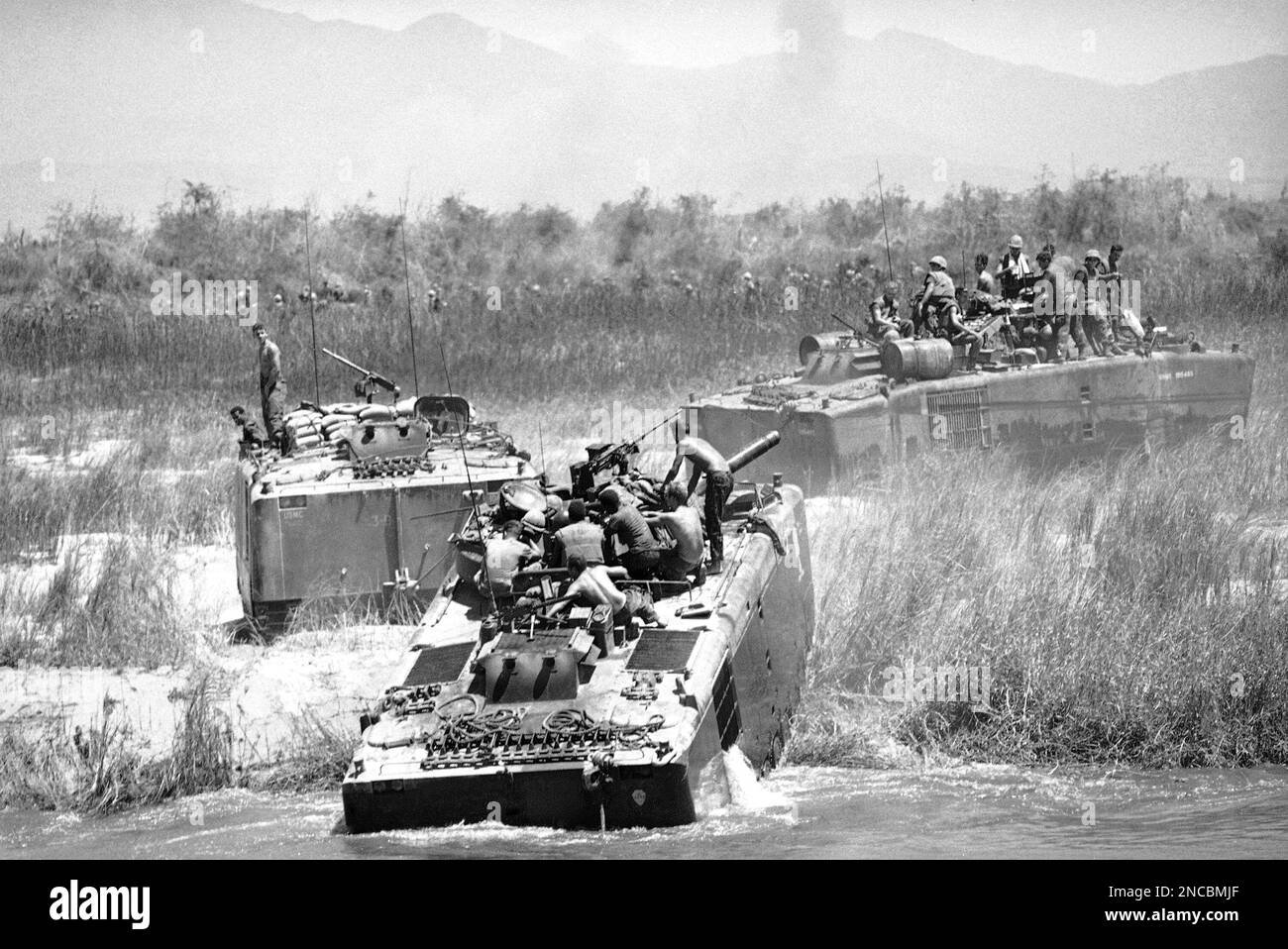 U.S. Marine amphibious troop carriers ford river south of Da Nang on ...