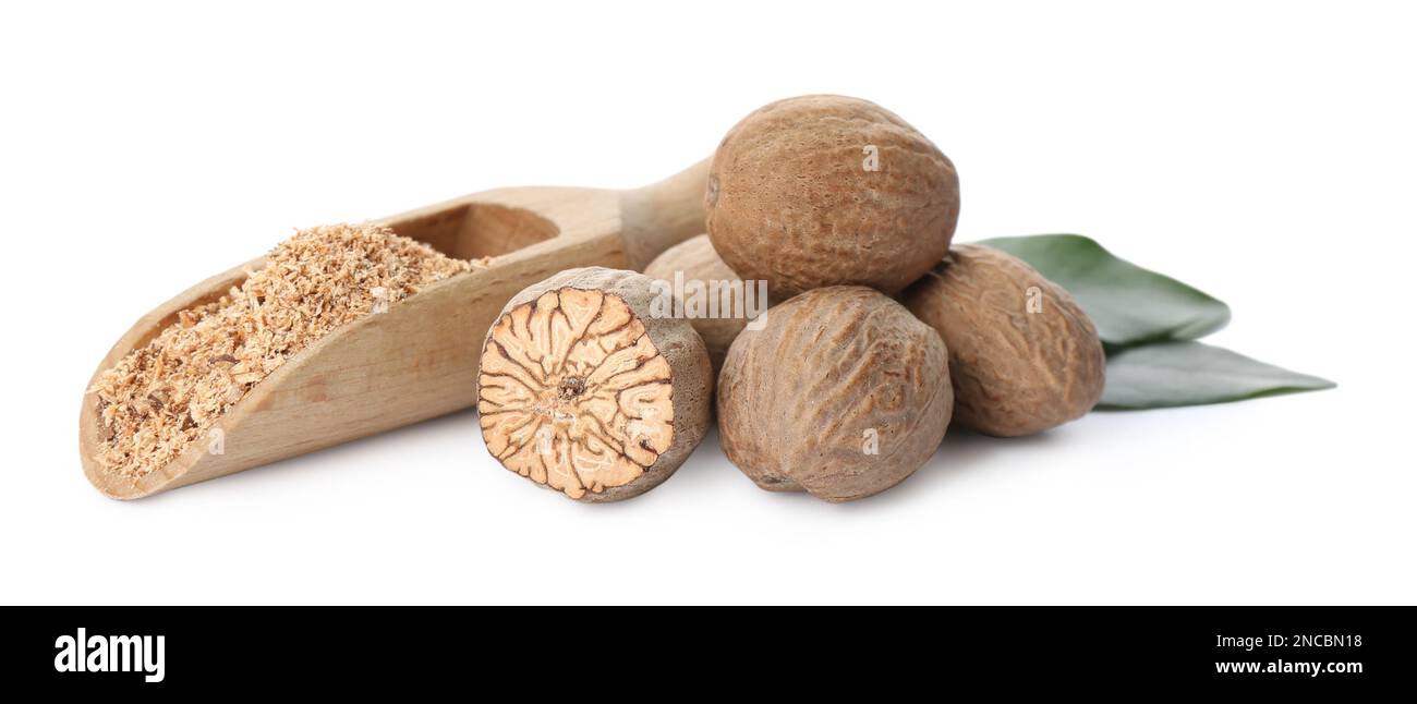 Grated nutmeg and seeds with green leaves on white background Stock ...