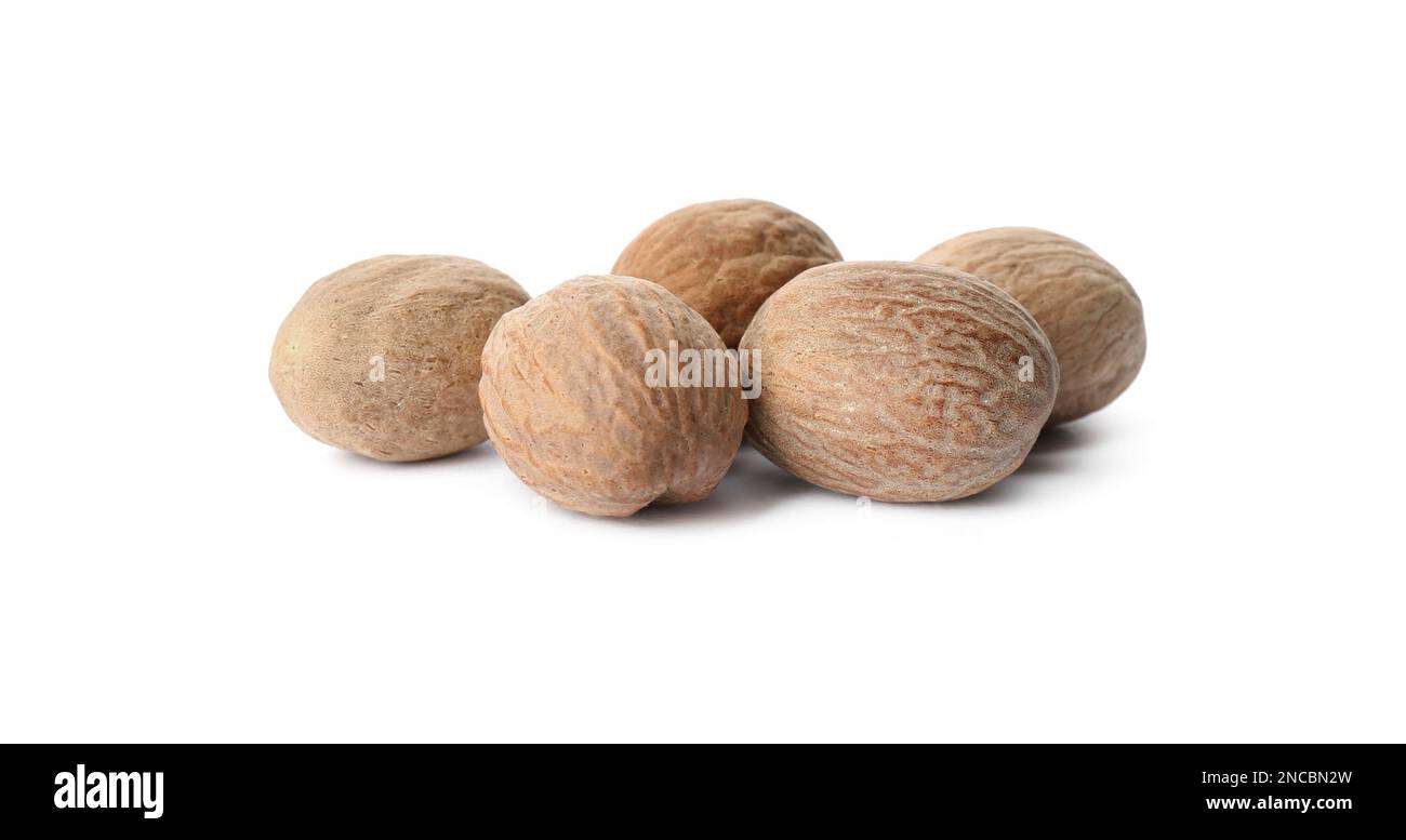 Heap of nutmeg seeds on white background Stock Photo - Alamy