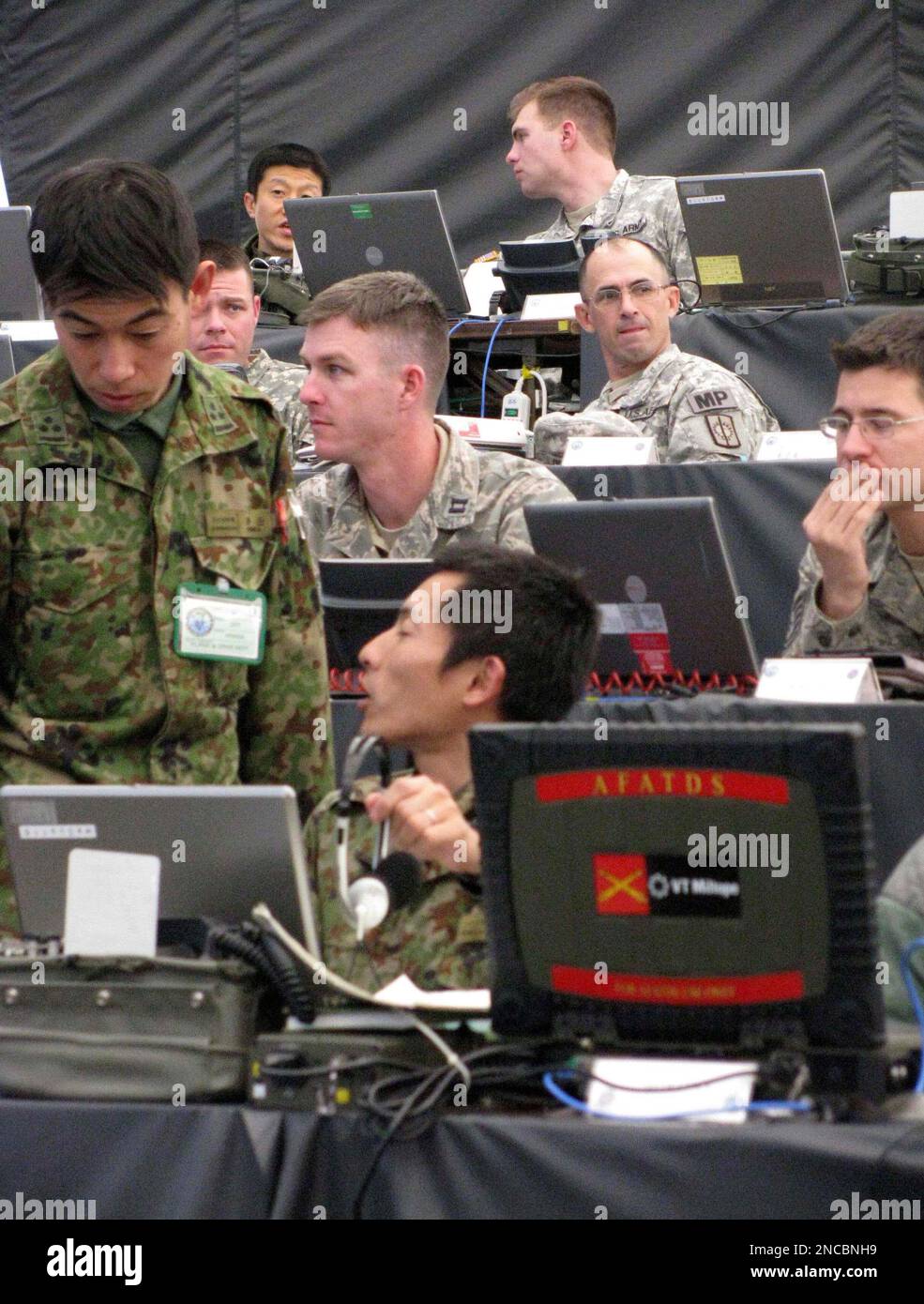 U.S. and Japanese soldiers follow computer simulations of an attack ...