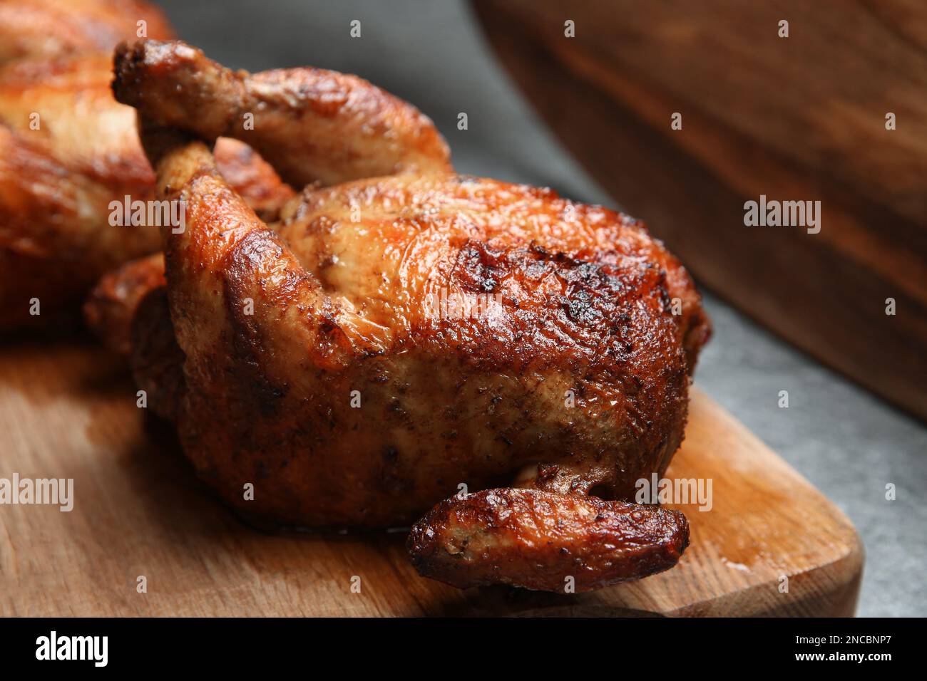 Delicious grilled whole chickens on grey table, closeup Stock Photo - Alamy