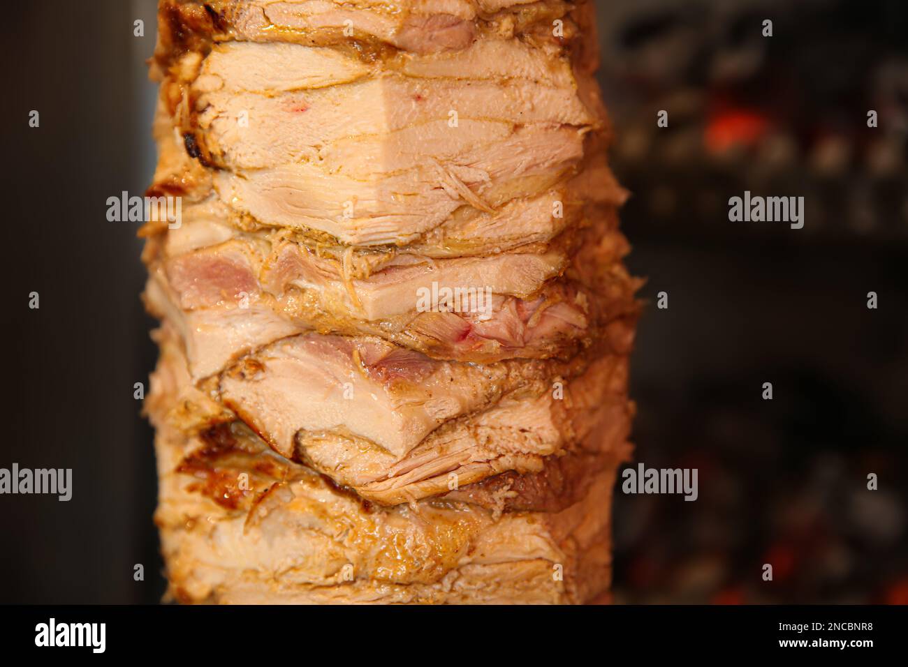 Vertical rotisserie with roasted meat, closeup view Stock Photo - Alamy