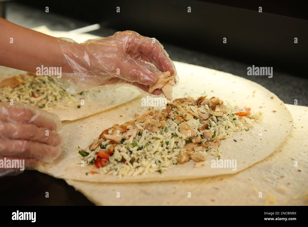 Chef cooking shawarma at black table, closeup Stock Photo - Alamy