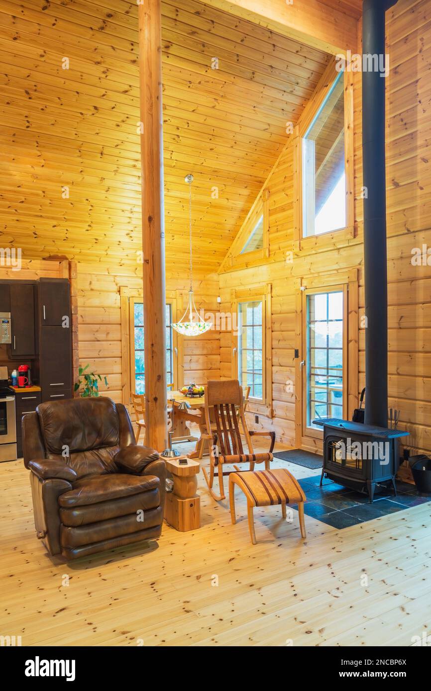 Living room with brown leather reclining armchair, wooden rocking chair ...