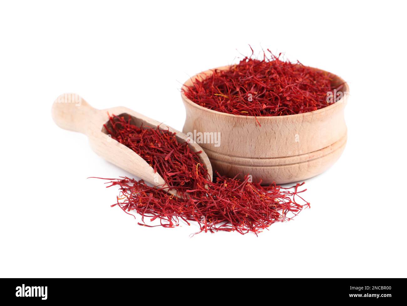 Dried saffron, wooden bowl and scoop on white background Stock Photo ...