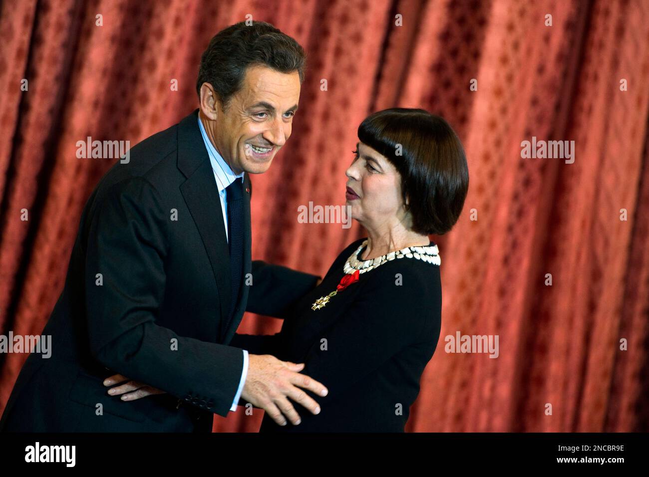 French singer Mireille Mathieu reacts with French Presidnt Nicolas ...