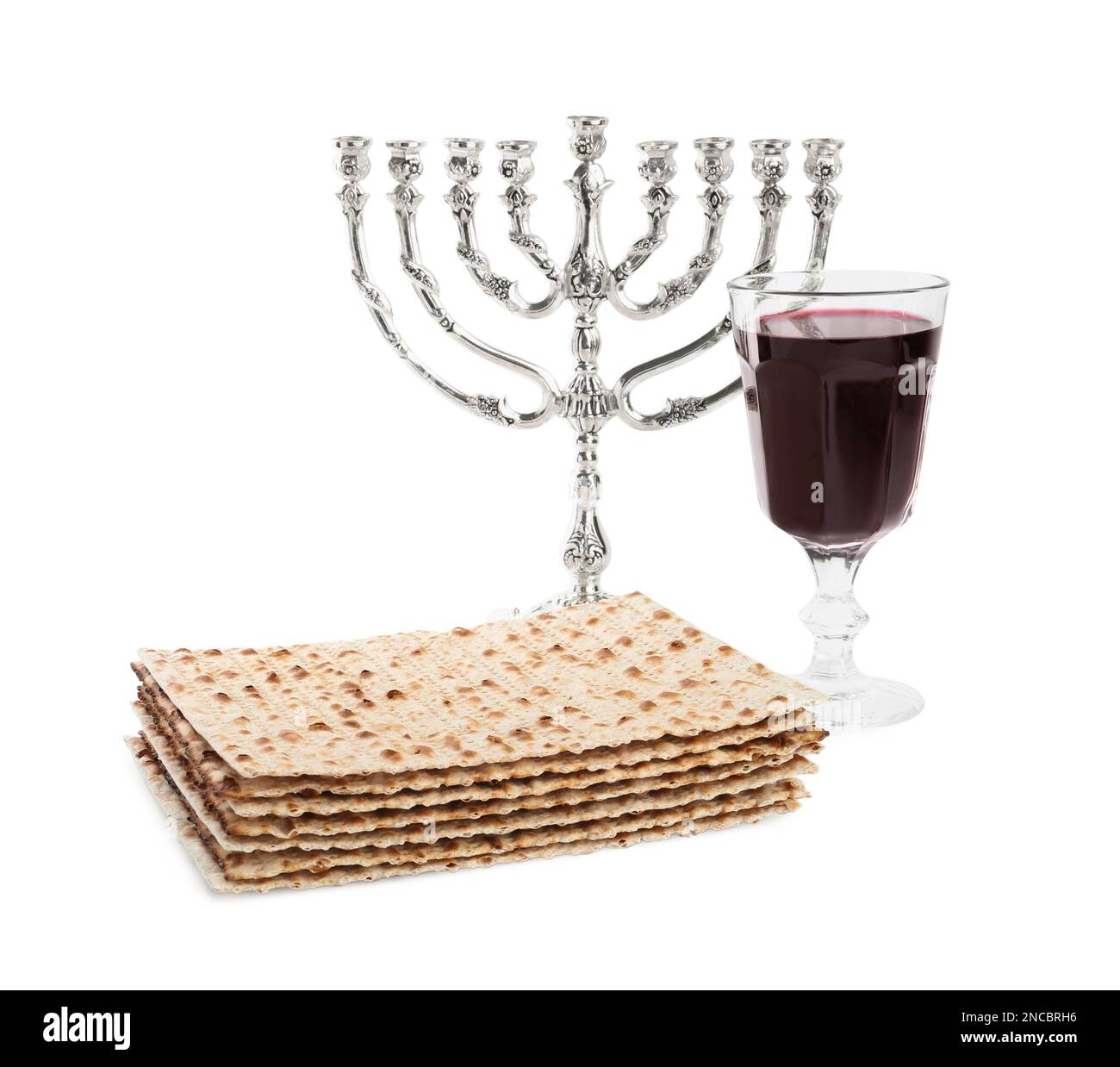 Traditional matzos, red wine and menorah on white background Stock ...