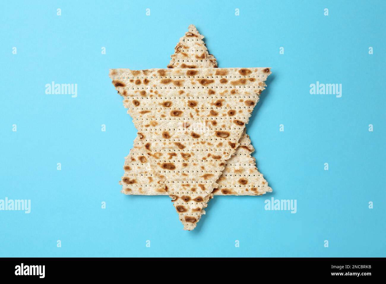 Star of David made with passover matzos on light blue background, top ...