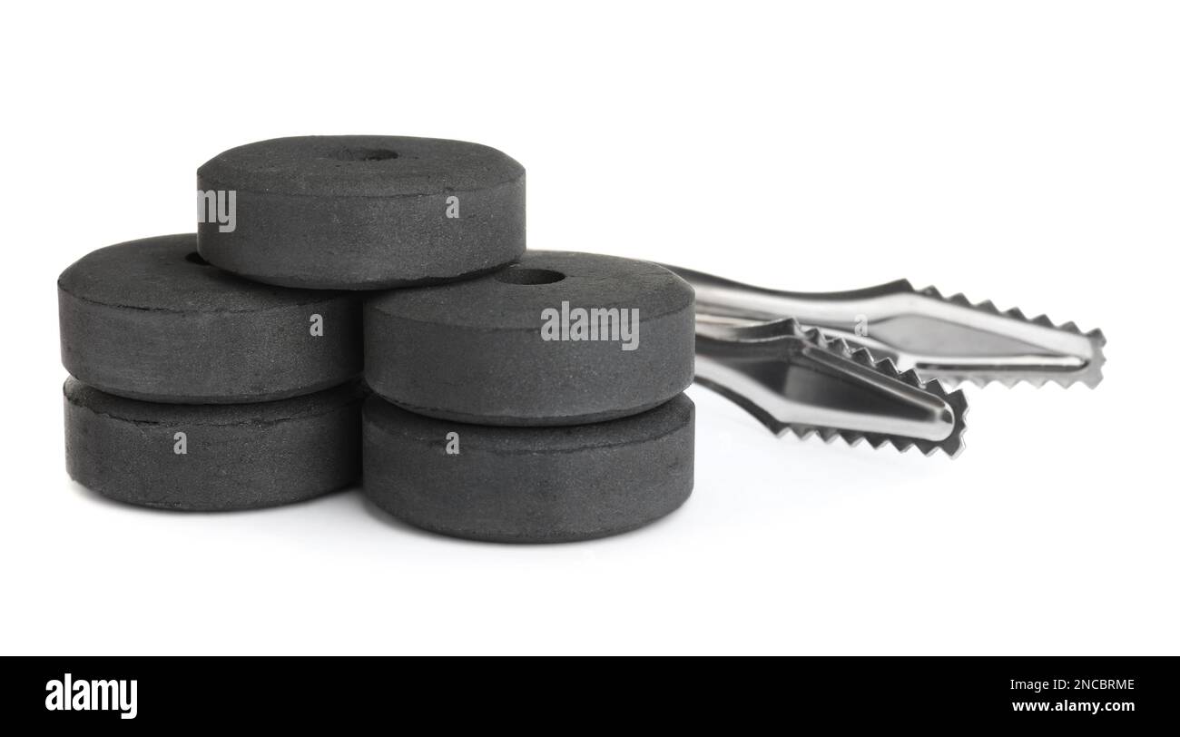 Charcoal rings for hookah and tongs on white background Stock Photo - Alamy