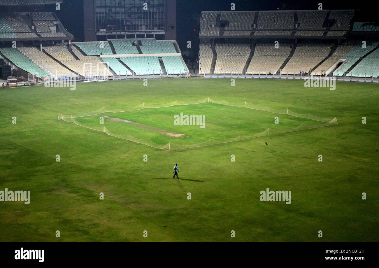 A man walks across the Eden Gardens stadium in Calcutta, India ...