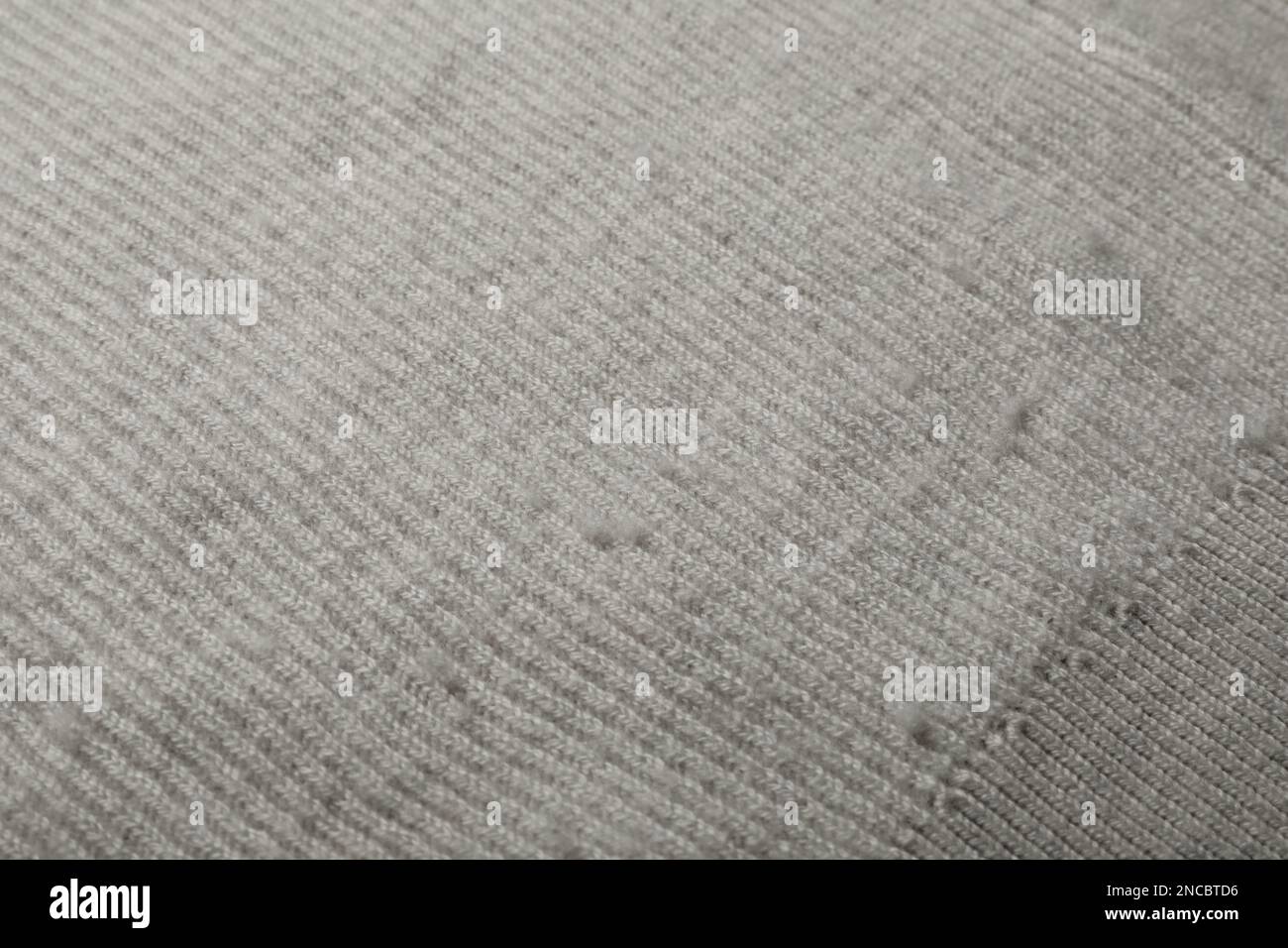 Light cloth with bobbles, closeup. Before use of fabric shaver Stock ...