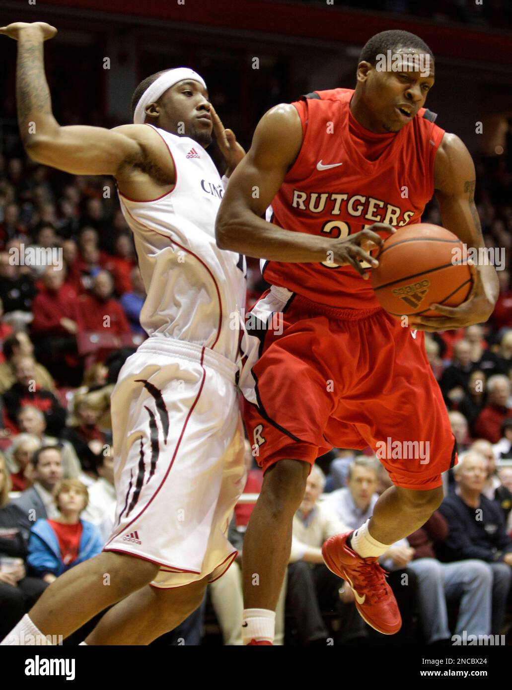 Rutgers guard Mike Coburn, right, takes a rebound away from Cincinnati ...