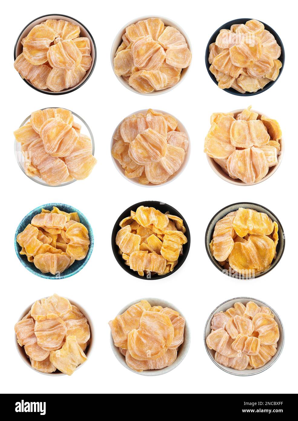 Set with sweet dried jackfruit slices in bowls on white background, top ...