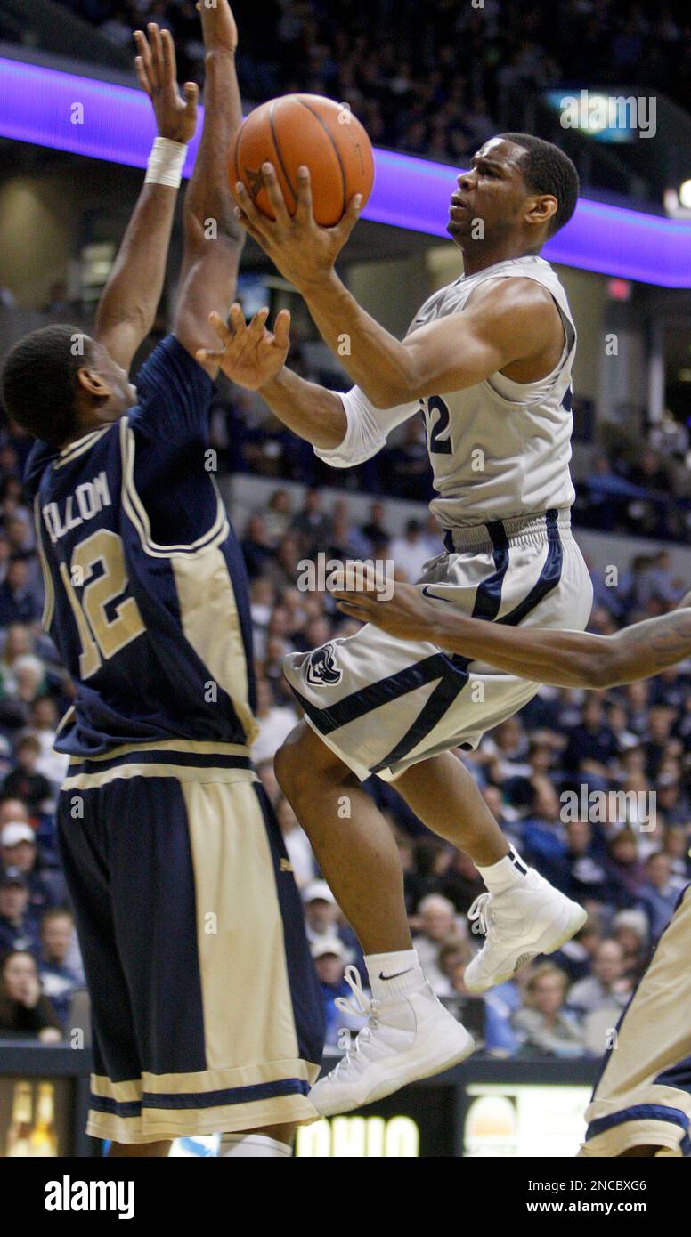 Xavier guard Tu Holloway, right, goes up for a shot against George ...