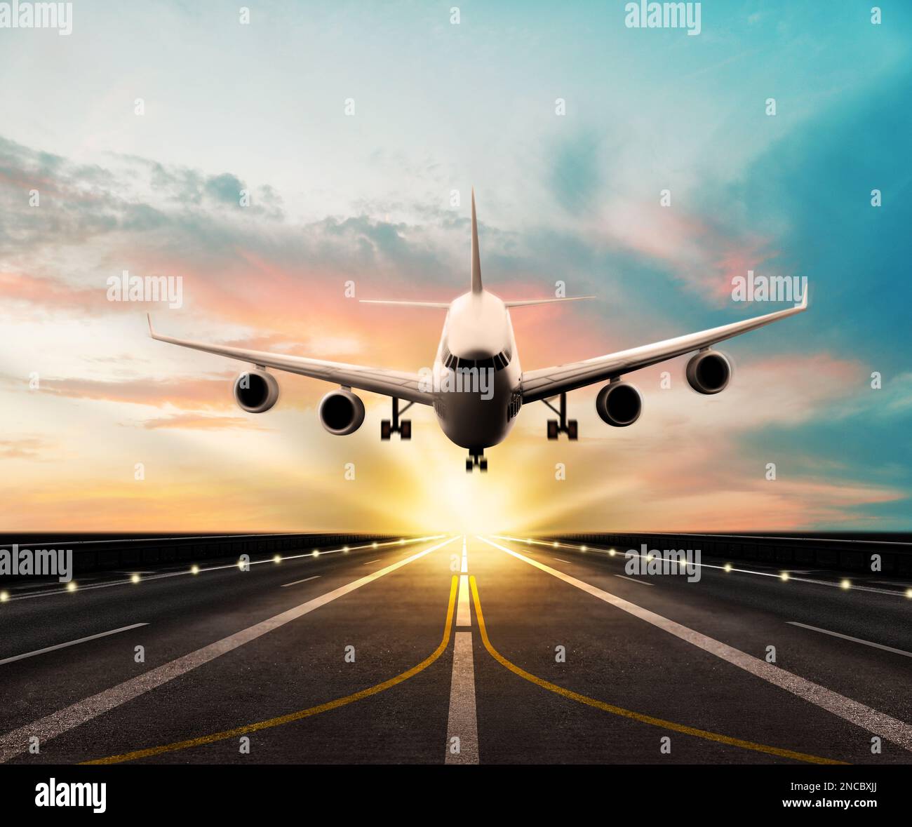 Modern white airplane landing on runway Stock Photo - Alamy