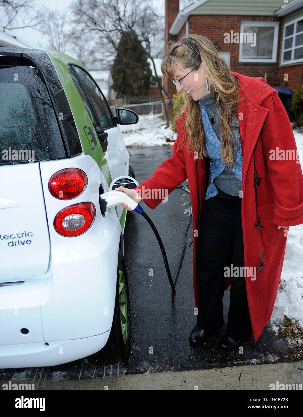 First smart fortwo electric drive customer, Mindy Kimball, poses at the ...