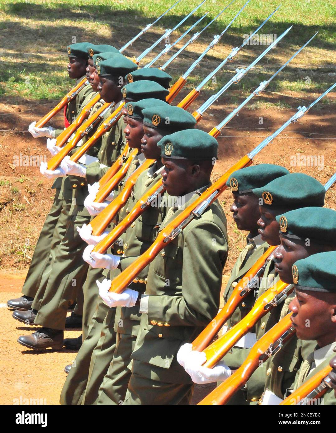 Members of the Uganda Peoples's Defense Forces (in green outfits) march ...