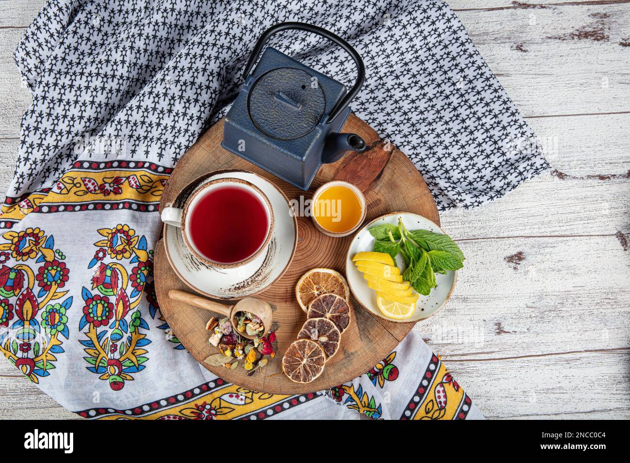 Cast iron blue teapot. Cinnamon sticks, name, Lemon slices and dried ...