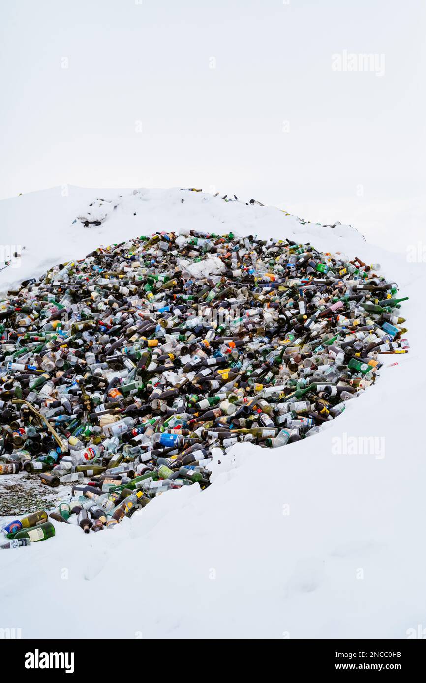 Heaps of empty alcohol bottles piled up. Snow Winter Background. Social ...