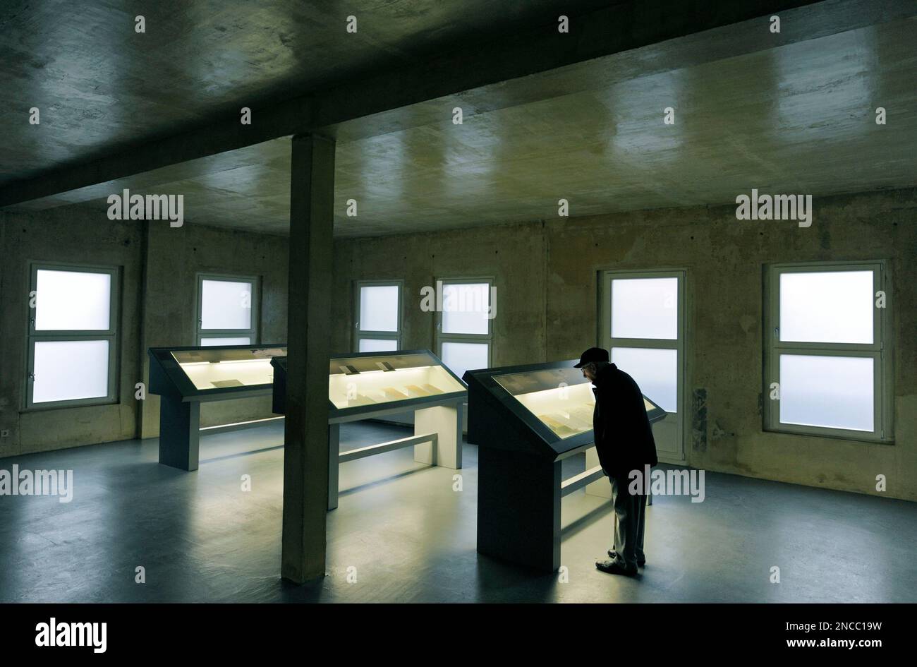 A man stands in the exhibition 'The Engineers of the 'Final Solution ...