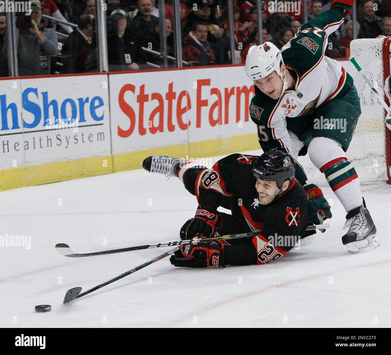 Chicago Blackhawks center Jake Dowell, left, and Minnesota Wild ...