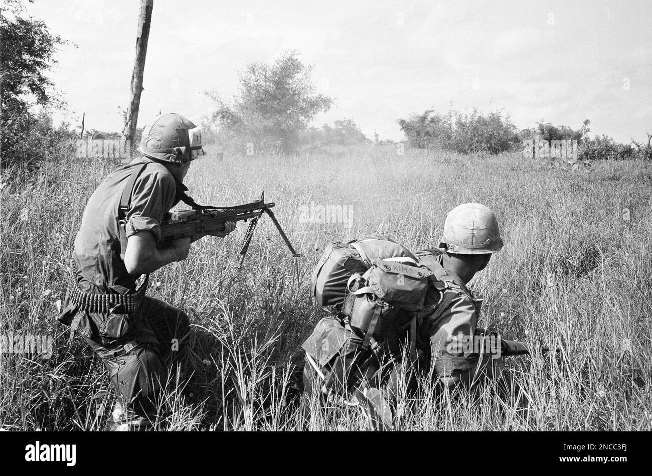 A machine gunner fires a burst into high elephant grass after sporting ...