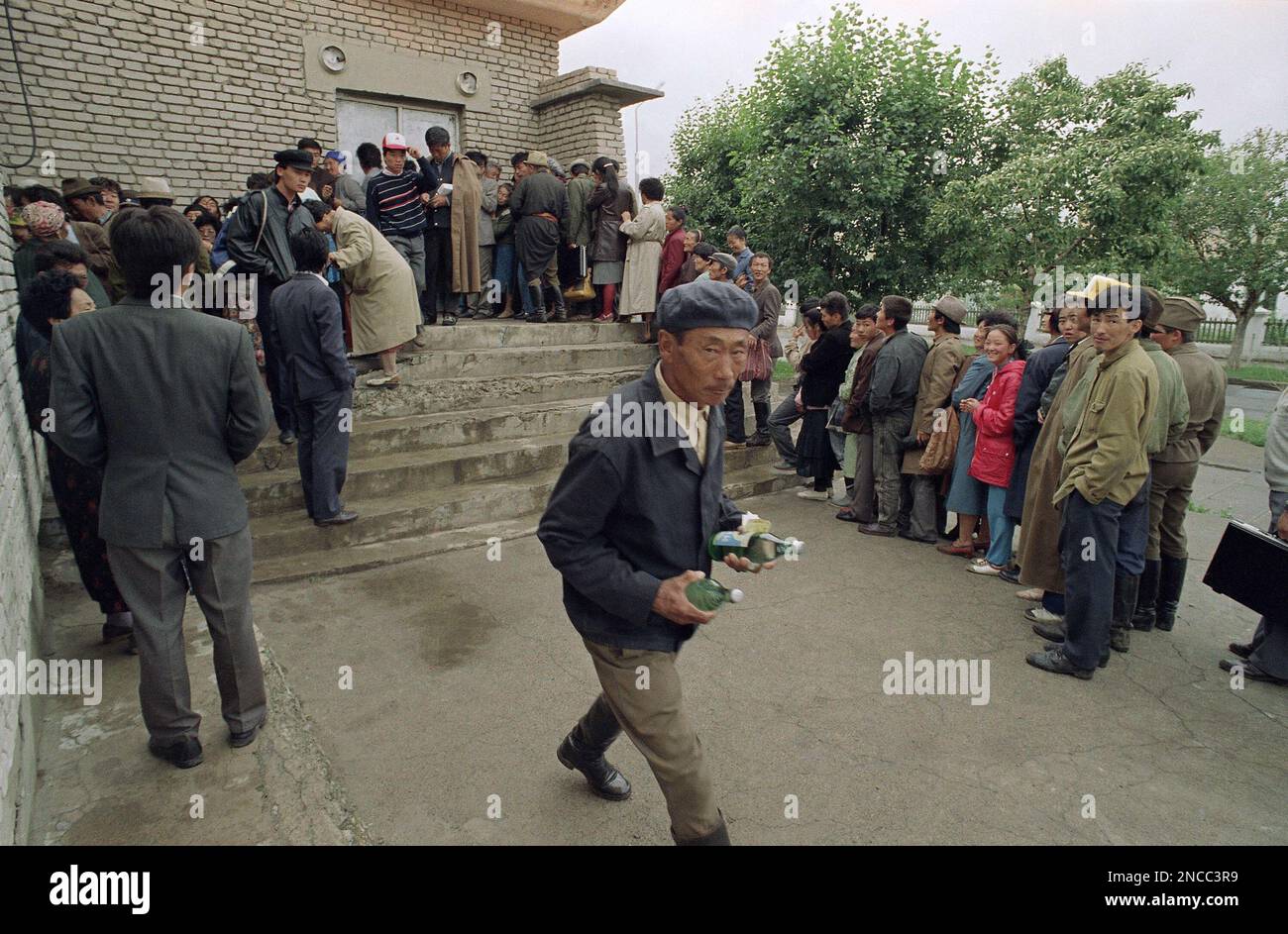 A long line to buy vodka forms in the Mongolian capital of Ulan Bator ...