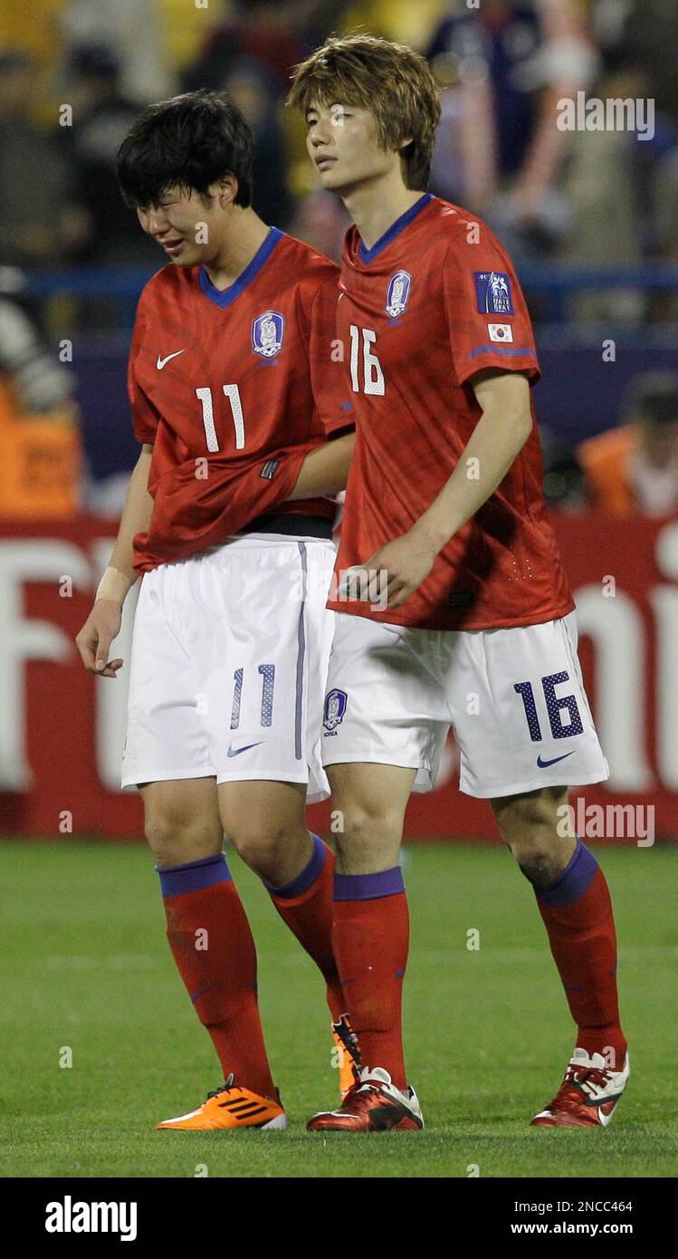 South Korea's player Son Heung Min, left, cries after lost the AFC ...