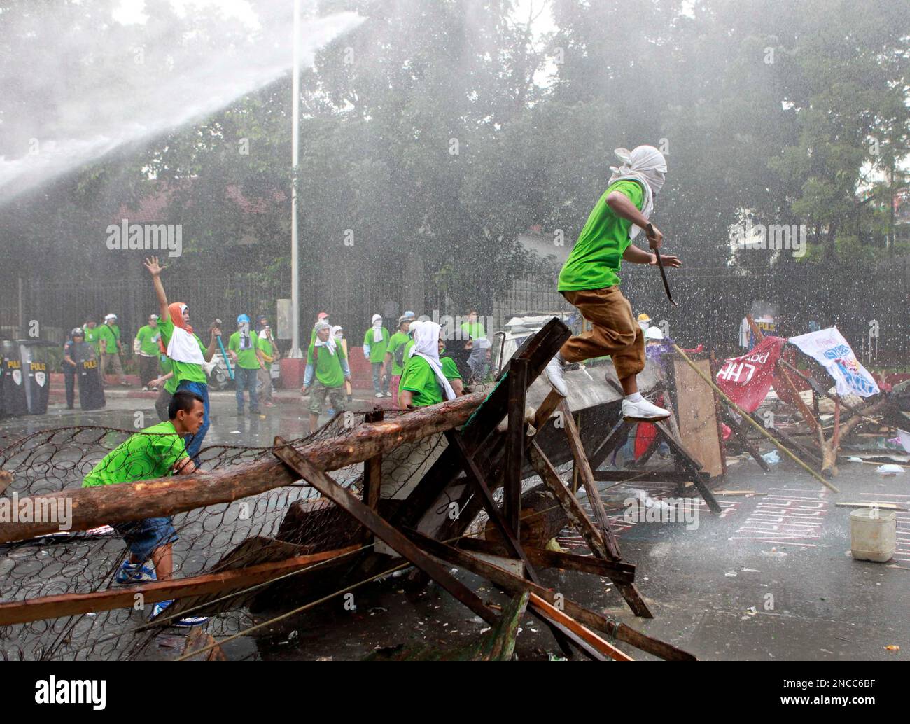 Advancing demolition crew remove the barricade which was set up by ...