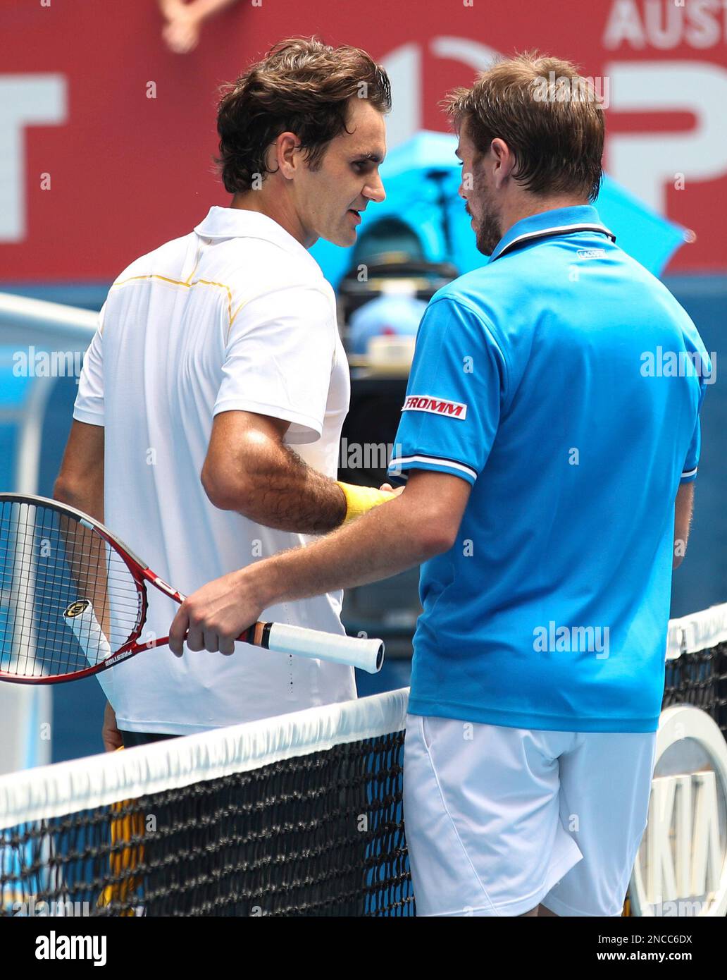 Switzerland's Roger Federer, left, shakes hands with compatriot ...