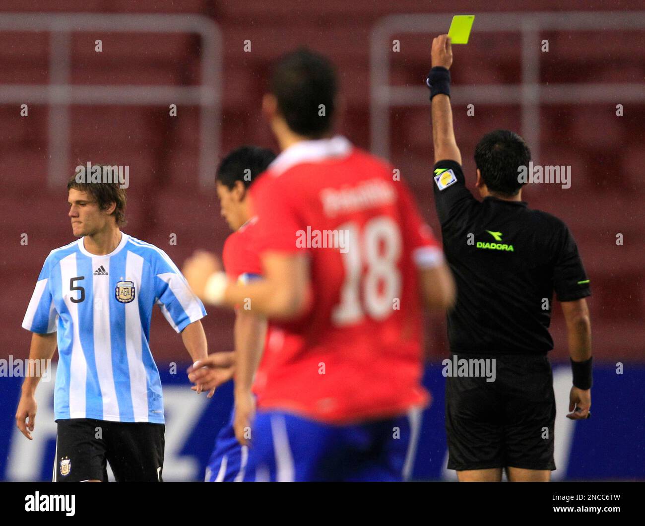 Bolivian referee Raul Orosco issues a yellow card to Argentina's Bruno ...