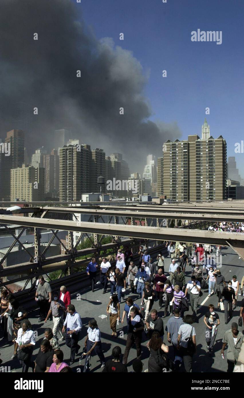 In this Sept. 11, 2001 photo, people walk over New York's Brooklyn ...