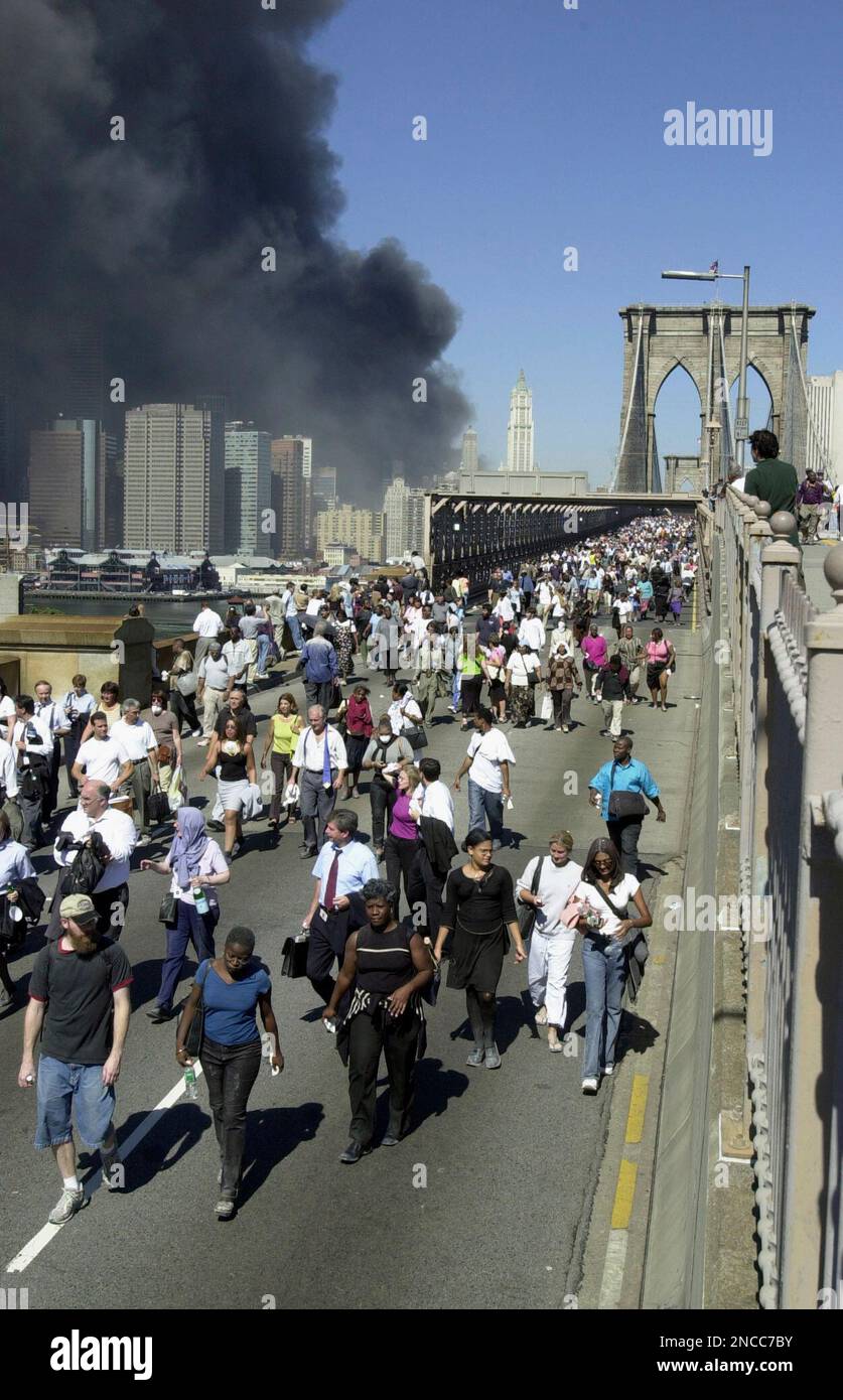 In this Sept. 11, 2001 photo, people walk over New York's Brooklyn ...